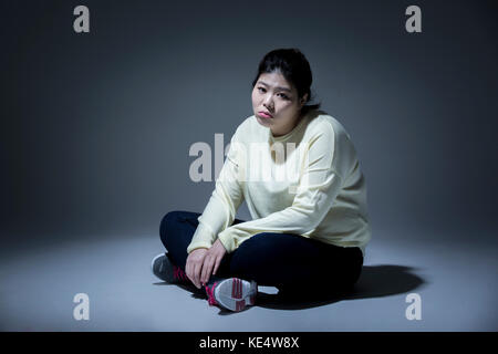 Young fat woman gloomy going on diet Stock Photo - Alamy