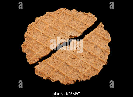 Round salted broken wafer isolated on black Stock Photo - Alamy
