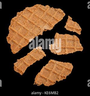 Round salted broken wafer isolated on black Stock Photo - Alamy