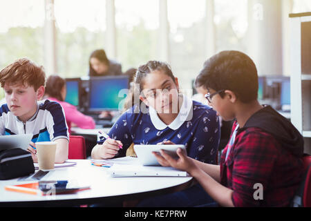 Schoolgirl Using Digital Tablet Taking Notes Learning Online At Home ...