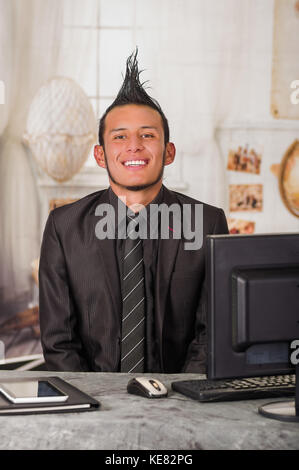 Close up of office punk worker wearing a suit with a crest, working in ...