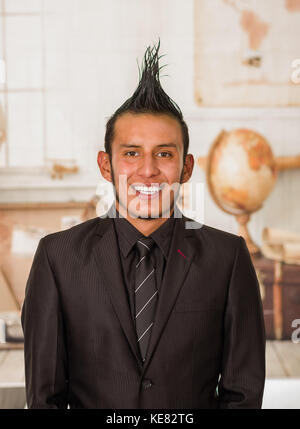 Close up of office punk worker wearing a suit with a crest, using his ...
