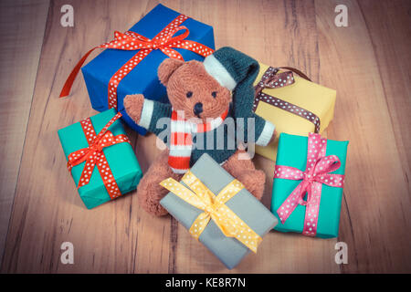 Vintage photo, Fluffy teddy bear and heap of wrapped colorful gifts for ...