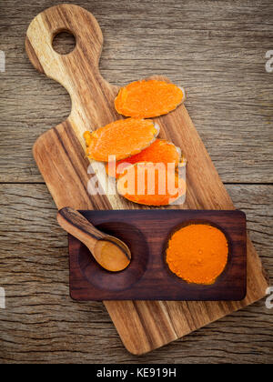 Board with turmeric mask and powder on blue background, closeup Stock Photo - Alamy