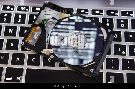 Illustration - open harddrive placed on laptop keyboard, Norden, Lower ...