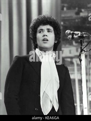 Italian singer-songwriter Lucio Battisti saddling his horse. Battisti ...