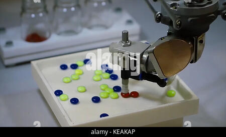 Automatic robot pharmaceutical industry. Robot automatically sorting ...