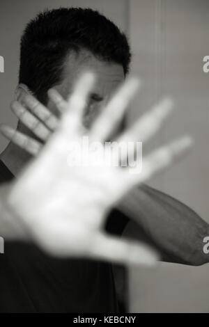 Man Blocking Face with Hands Stock Photo - Alamy