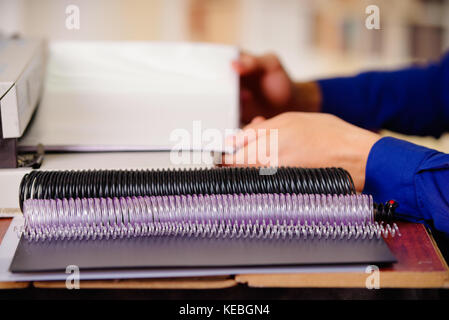 Cose up of plastic ring of different sizes and colors used for binding ...