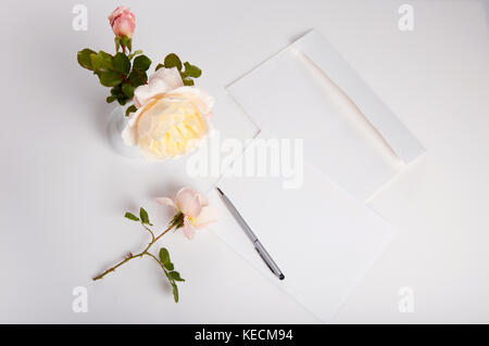 Blank diary with a pink rose, gift wrapped in cloth, apron on a wooden ...