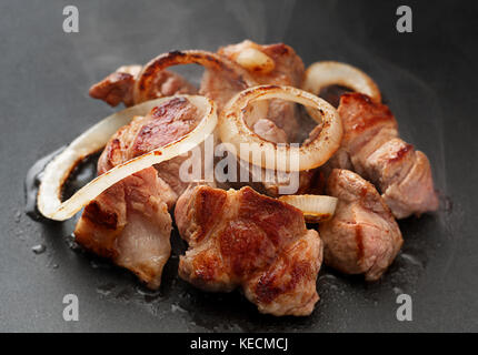 Grilled meat with orion rings on grill table Stock Photo - Alamy
