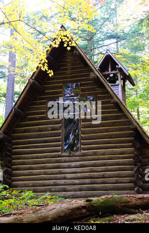 Christian church chapel woods forest dusk people going inside, lights ...