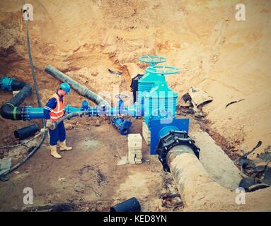 Worker works underground for reconstrucion of drink water system ...