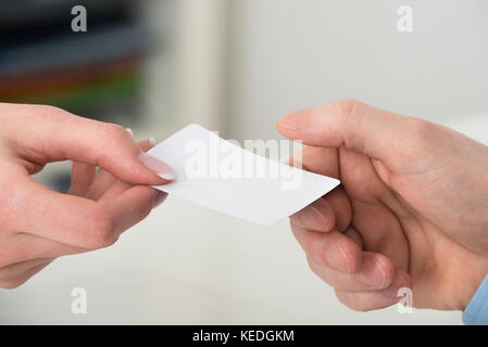 Close-up of two businesspeople exchanging visiting card Stock Photo - Alamy