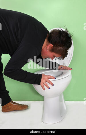 Woman throwing up in the toilet isolated on white background Stock ...