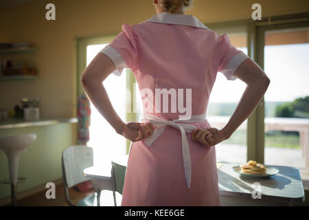 Rear view of waitress wearing a apron in restaurant Stock Photo - Alamy