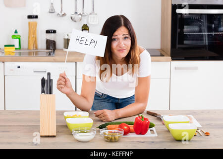 Young woman at home holding flag of France pointing with hand and ...