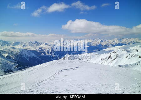 Panoramic view on snowy off-piste slope with skier and snowboarders at ...