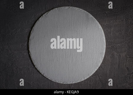 Empty black round slate serving board on white background with rustic ...