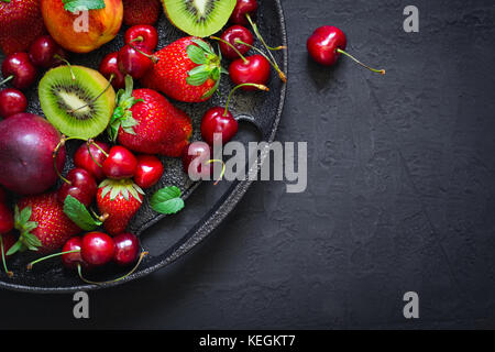Selection of seasonal fruits and berries on a cast-iron dish. To Stock ...