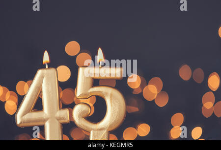 Number 45 gold celebration candle and gift box background Stock Photo ...