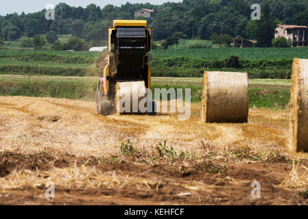 Tractor and hay baling baling hay in field, Oxfordshire, England Stock ...
