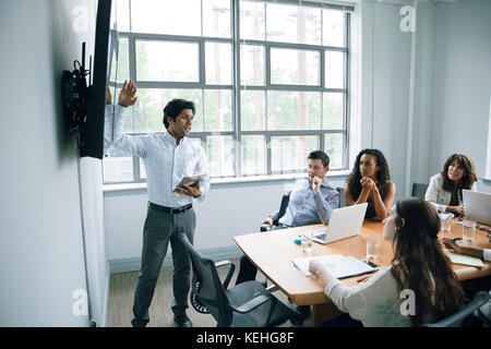Businessman talking near visual screen in meeting Stock Photo - Alamy