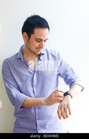 smiling man checking time. guy with hand watch. man showing wristwatch ...