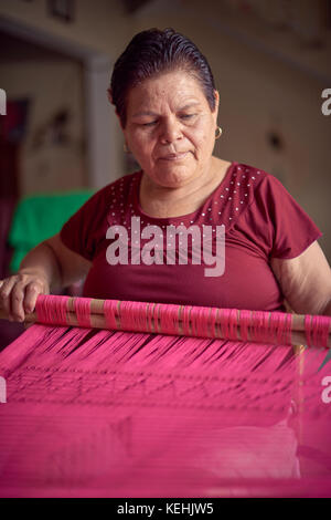 Hispanic woman weaving fabric on loom Stock Photo - Alamy