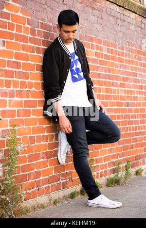 Pensive black man standing outside in city downtown. Thoughtful African ...