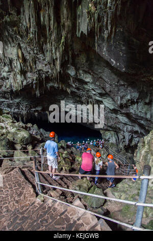 Tourists visiting the Gruta do Lago Azul [grotto of the blue lake] at ...