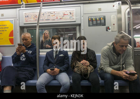 People constantly are on their cell phones when riding the subway ...