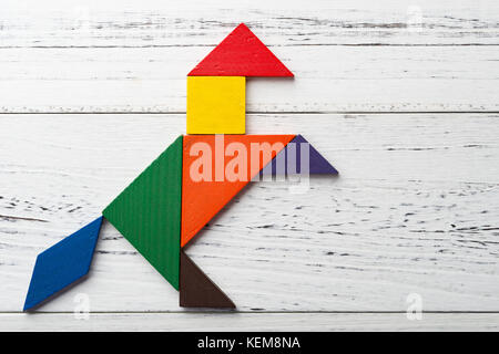 Wooden tangram in horse shape on white background (Concept for energy ...
