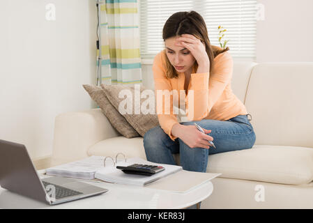 Sad woman accountant sitting at table in her workplace Stock Photo - Alamy