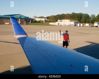 Ground crewman guiding an aircraft Stock Photo - Alamy