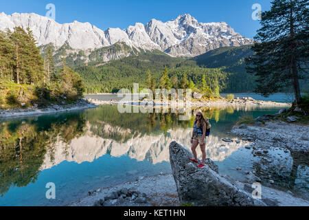 Woman at lake Eibsee, mountains Zugspitze, Grainau, Bavaria, Germany ...