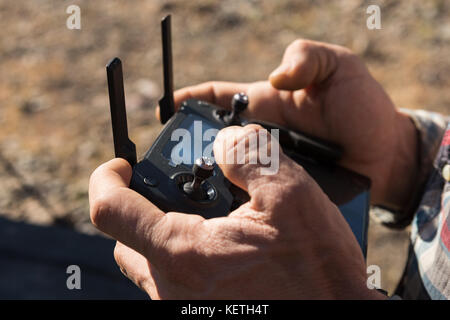 A male's hands operating a joystick of a Mavic Pro drone Stock Photo ...