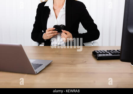 A Young Woman Stealing Computer Mouse From Office Desk Stock Photo - Alamy