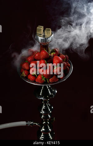 East smoking shisha with tobacco with strawberry flavor Stock Photo - Alamy
