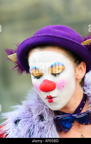 A woman clown performs on the street as she takes part during the ...