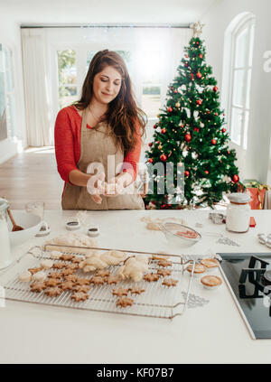 Young woman Making gingerbread cookies. Preparation for Christmas ...