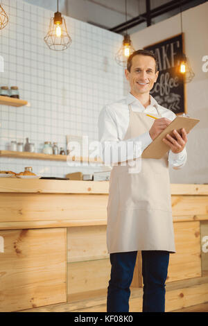 Joyful smart man taking notes Stock Photo - Alamy