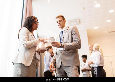 Smiling asian business woman with smartphone in office. Woman in casual ...