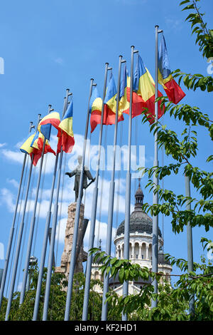 Sunny blue sky and flags of romania and angola Stock Photo - Alamy