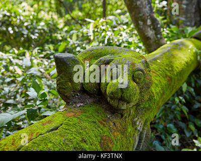 Monkey statue in covered with moss, Indonesia Stock Photo - Alamy