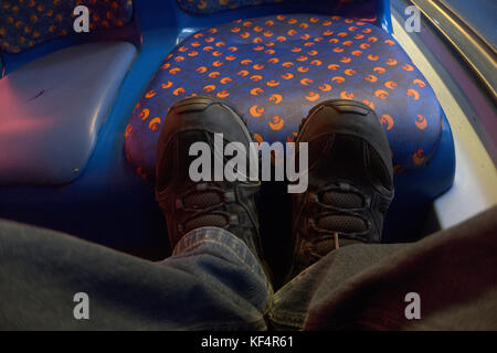 Feet on bus seat Stock Photo - Alamy