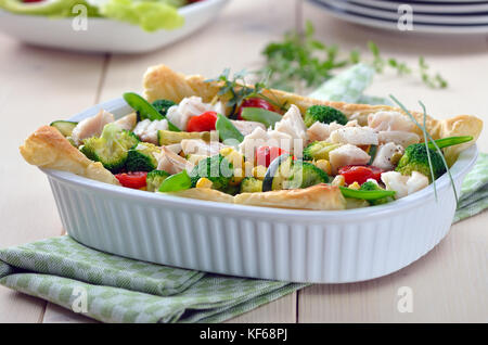 Cod fillet on mixed vegetables in season baked on puff pastry Stock ...