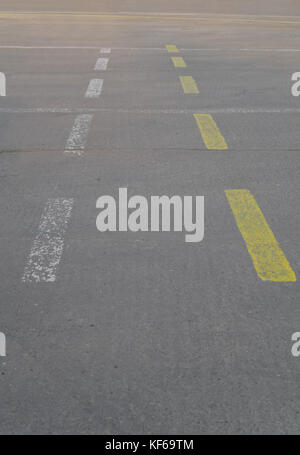 Road asphalt with yellow and dashed white stripe Stock Photo - Alamy