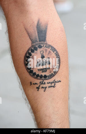 A veteran shows his Invictus tattoo while attending a Rolling Floorball ...