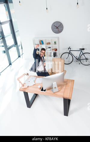 Cheerful businessman triumphing Stock Photo - Alamy